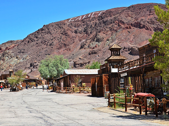 Calico Ghost Town's wooden buildings stand against the dramatic desert landscape, like a movie set waiting for cowboys to arrive.