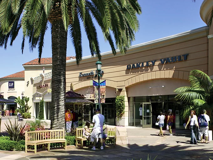 Carlsbad Premium Outlets' palm-lined entrance says "Welcome to Shopping Paradise" without saying a word. California casual meets serious deals!