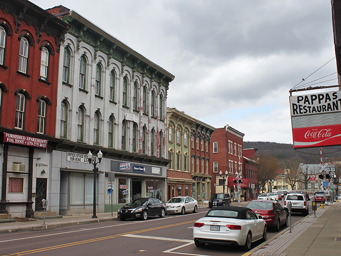 Riverside town charm flows through streets where historic buildings house modern conveniences at yesterday's prices.