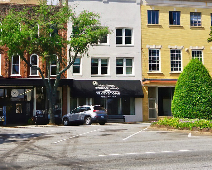 Forest City's main street stretches toward mountain horizons, promising adventure without the tourist trap prices.