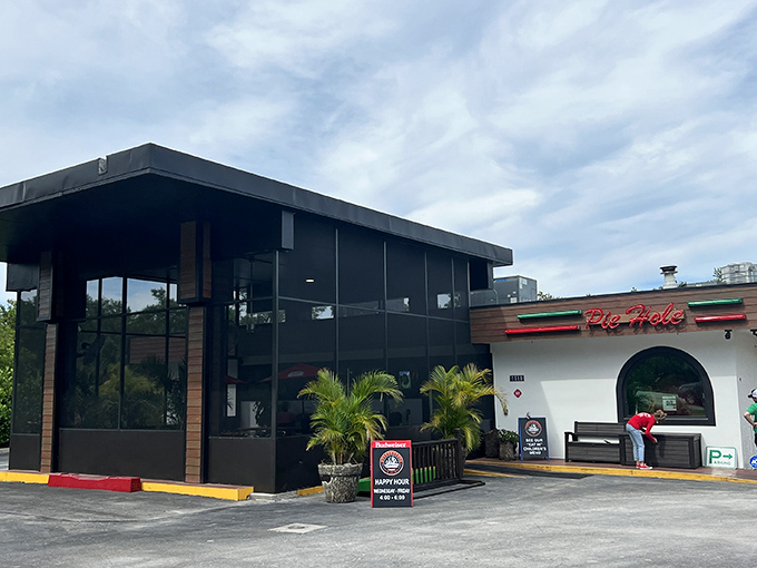 By day, a simple white building—by night, a neon-lit temple of wood-fired pizza worship.