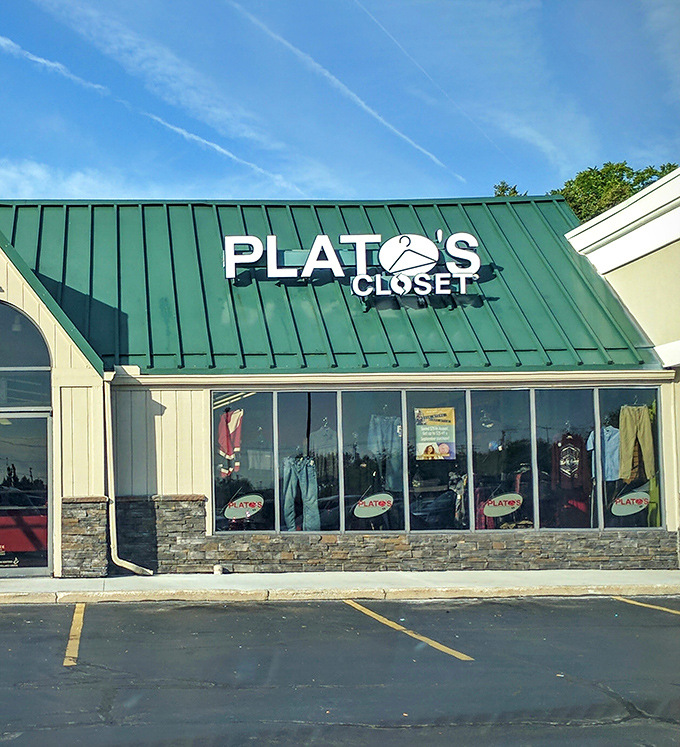 Plato's Closet's trendy green roof and stone accents attract fashion-forward shoppers seeking name-brand clothes at thrift prices.
