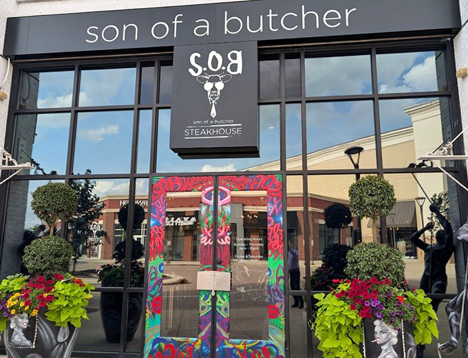 Son of a Butcher's sleek black exterior and vibrant doorway set the tone: traditional steakhouse meets modern sensibility. Serious meat with a splash of fun.