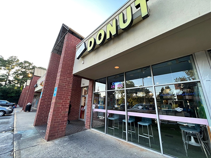 Blue shelves showcase donut artistry like a museum dedicated to morning happiness and sugar.