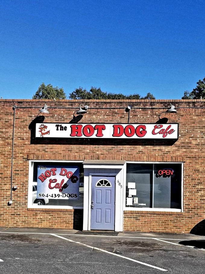 The cheerful red sign and brick facade promise the kind of neighborhood warmth money can't buy.