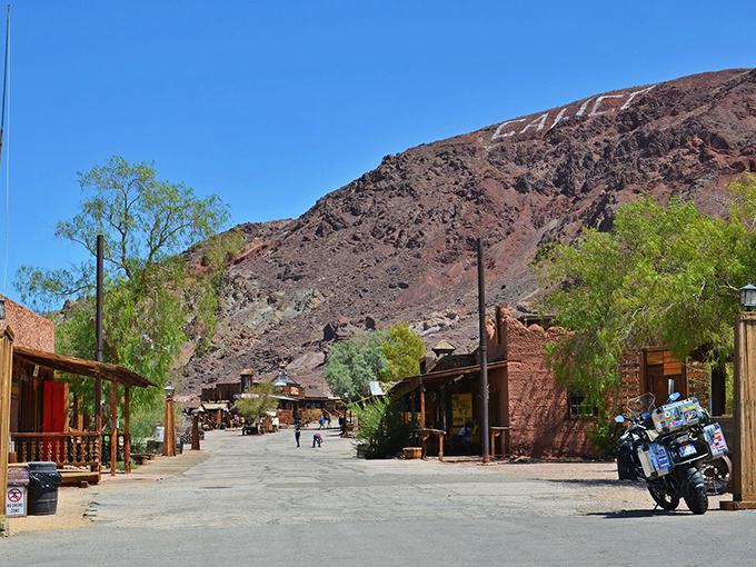 The weathered structures of Calico Ghost Town tell silent stories of boom and bust against the striking red-hued mountains.