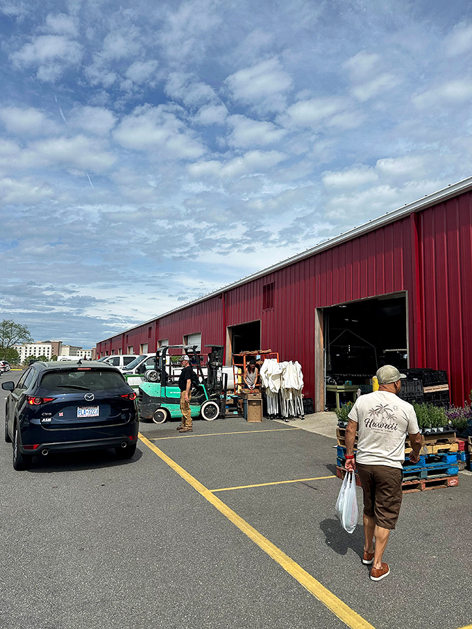 Shoppers explore the massive interior space where fresh produce meets vintage treasures in perfect harmony.