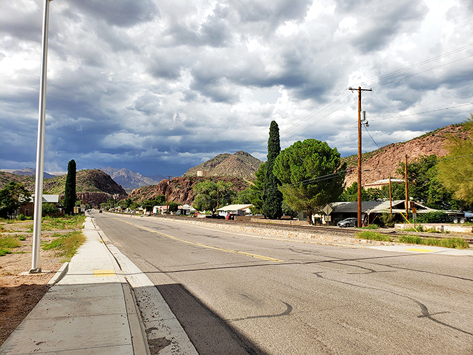 The road through Clifton leads to budget-friendly bliss, where green trees defy the desert and prices defy inflation under dramatic skies.