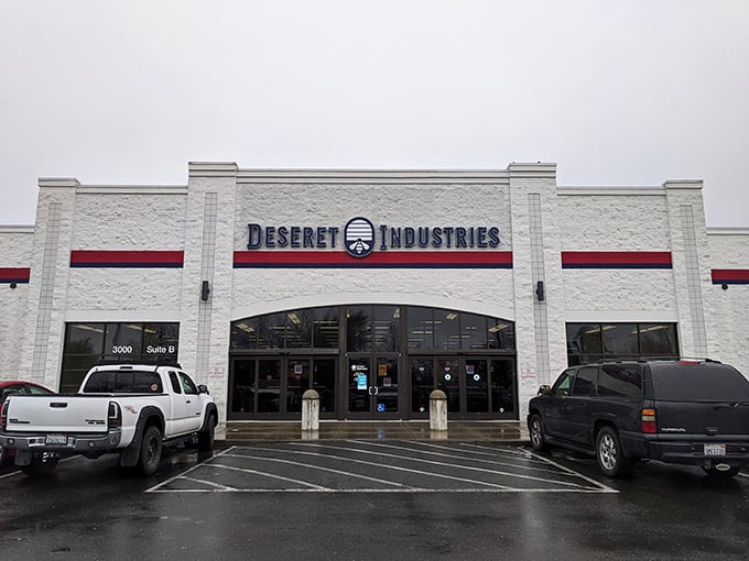 Rain can't dampen the thrill of finding treasures at Deseret Industries. Their distinctive logo welcomes bargain hunters seeking quality at unbeatable prices.