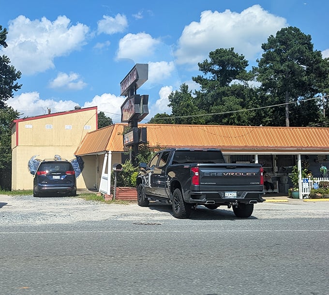 White picket fence meets metal roof - this roadside gem serves burgers with a side of small-town charm.