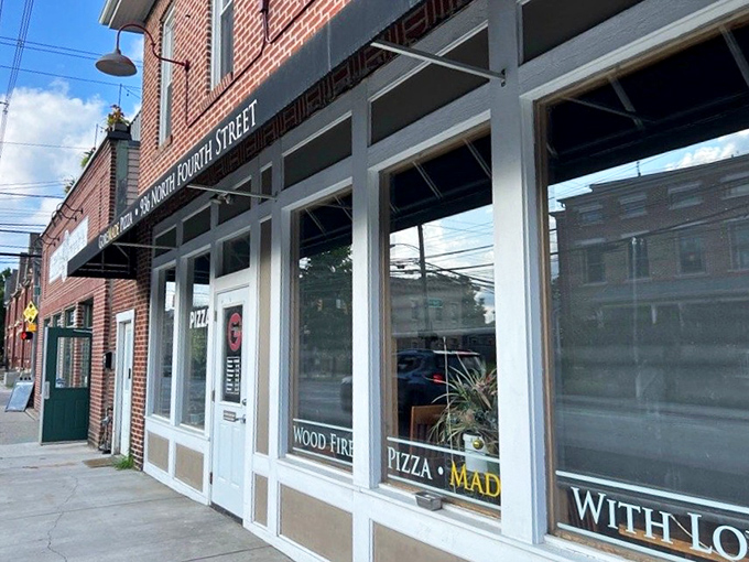 That simple storefront promises big flavors - sometimes the best pizza comes from the most unassuming places.