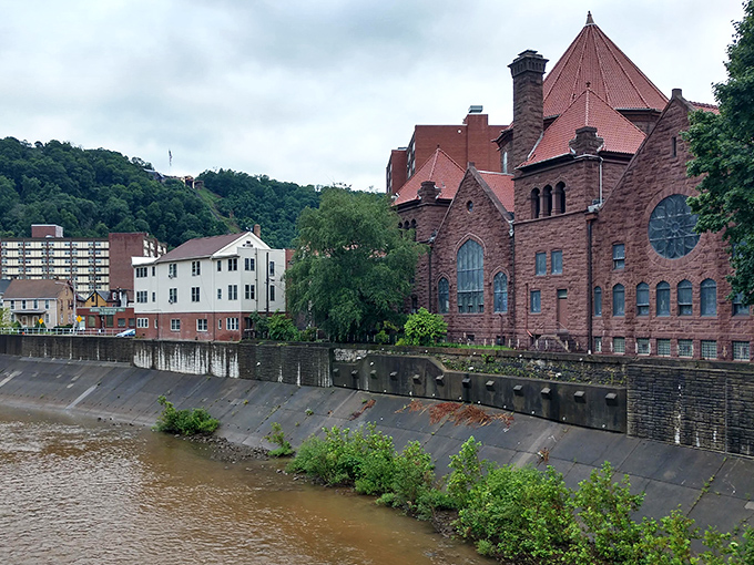 The rushing waters beside Johnstown's historic buildings remind us that this resilient city offers both natural beauty and affordable living.