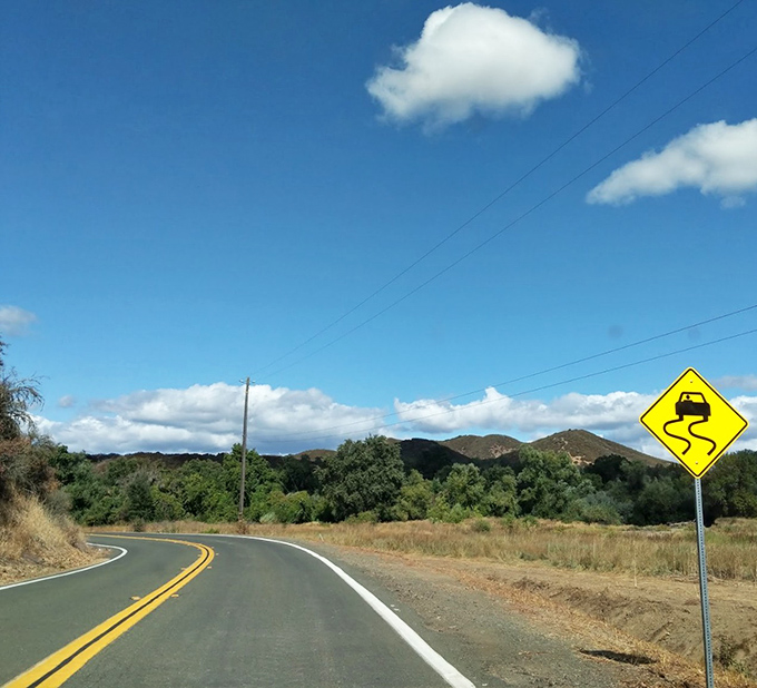 A mountain road winds its way to timeless charm, the perfect backdrop for comfortable, affordable living.