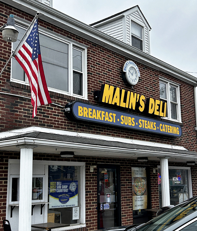 That clock on Malin's brick façade isn't just telling time—it's counting down the minutes until your next perfect sandwich experience.