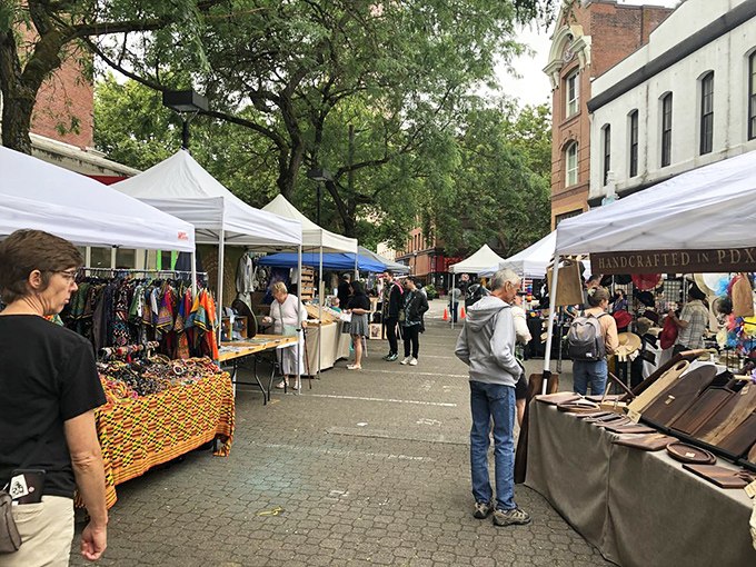 The tree-lined streets of Portland Saturday Market create a perfect backdrop for discovering handmade crafts and vintage treasures.