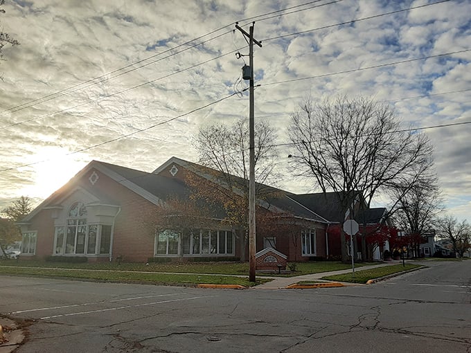 Take a peaceful walk past this beautiful brick building, where the morning sun highlights the classic design and quiet surroundings.