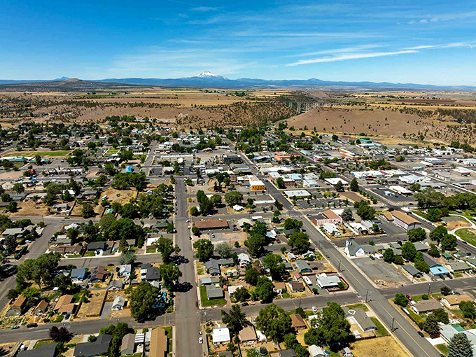 Snow-capped peaks rise above the horizon in Prineville, where you can admire the expansive high desert landscape and quiet neighborhoods.