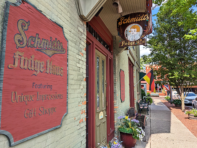 Schmidt's Fudge Haus sign swinging gently in the breeze. Where German traditions and sweet treats create the perfect Old World charm.