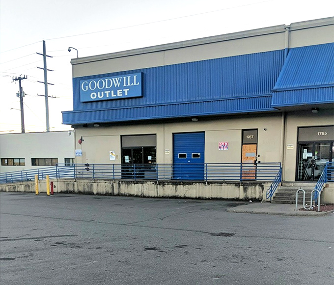 Blue awnings signal serious savings! Seattle's Goodwill Outlet might look unassuming, but inside awaits the ultimate thrift adventure.