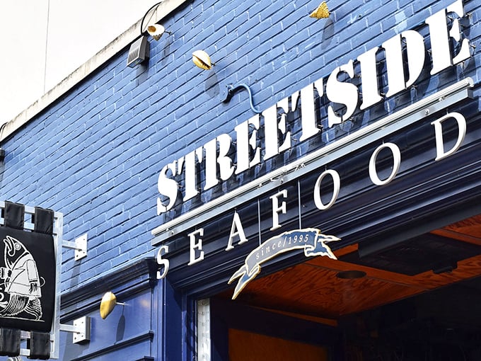 Flower-adorned outdoor seating creates the perfect spot for savoring fresh oysters while watching Birmingham's bustling streets.