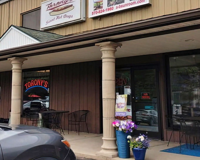 Simple columns frame a doorway to hot dog heaven. Sometimes the most memorable meals come from the most forgettable buildings.