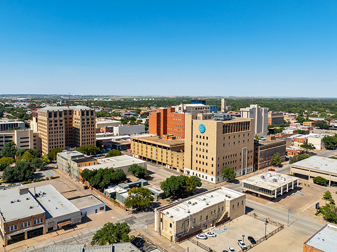 The city's skyline reflects in still waters, creating a mirror image of small-town dreams made wonderfully real.