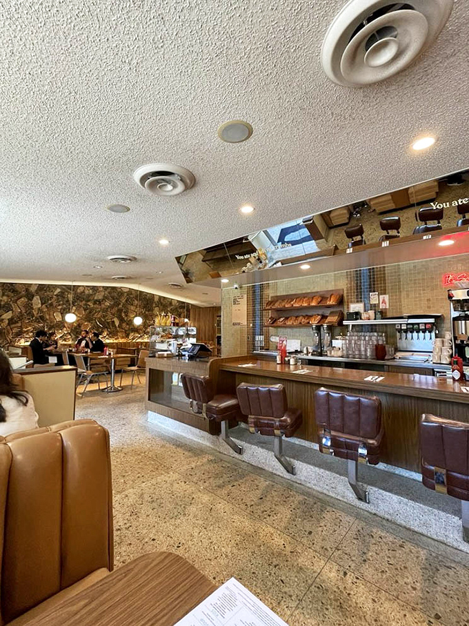 Classic counter seating with those swivel stools that make everyone feel like they're in a 1950s film, even if you're just doom-scrolling between bites.