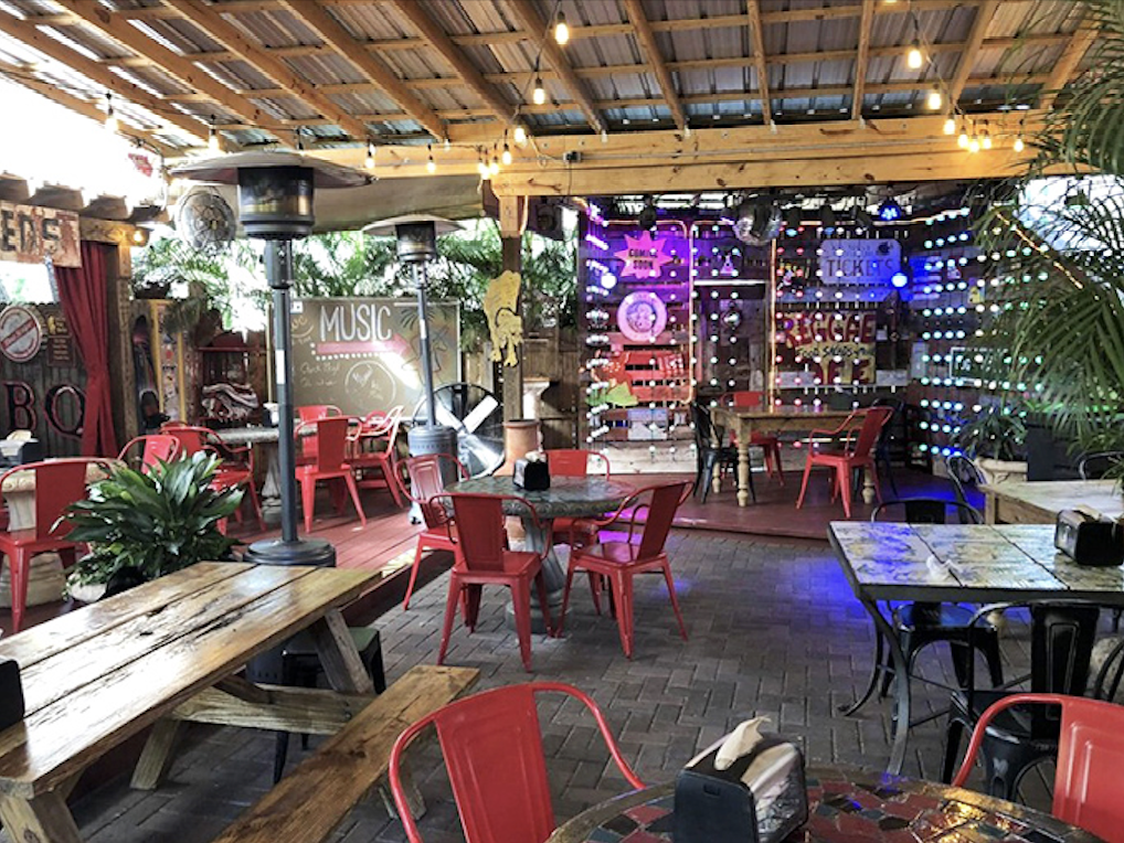 The outdoor seating area strikes that perfect Florida balance&mdash;just enough cover to escape the sun, just enough openness to enjoy the breeze.