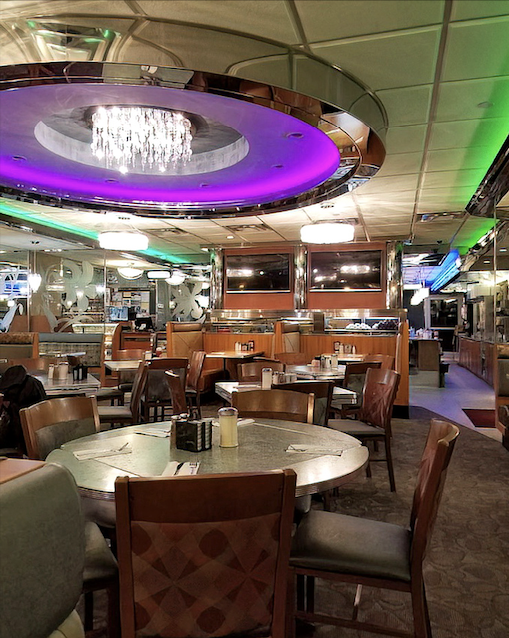 Modern meets nostalgic with color-changing ceiling lights illuminating comfortable booths where countless conversations and comfort meals have unfolded.