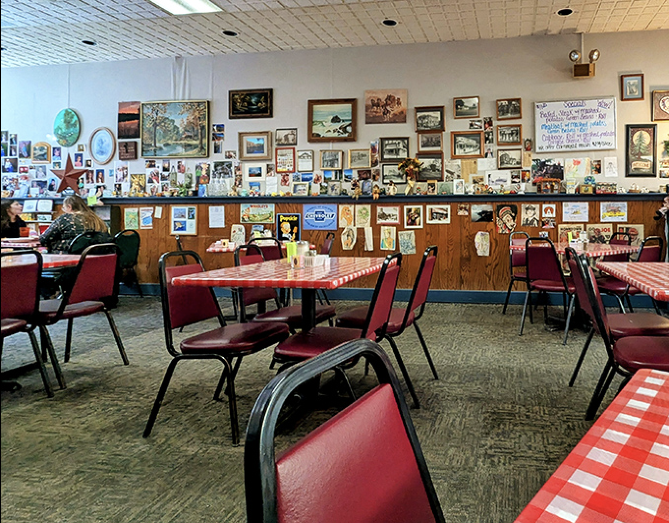 Inside, the walls tell stories through countless photos and mementos, creating that rare atmosphere where every table feels like the best seat in the house.