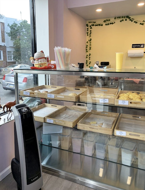 Simple wooden trays showcase the bakery's treasures, proving that sometimes the most unassuming displays hold the most extraordinary treats.