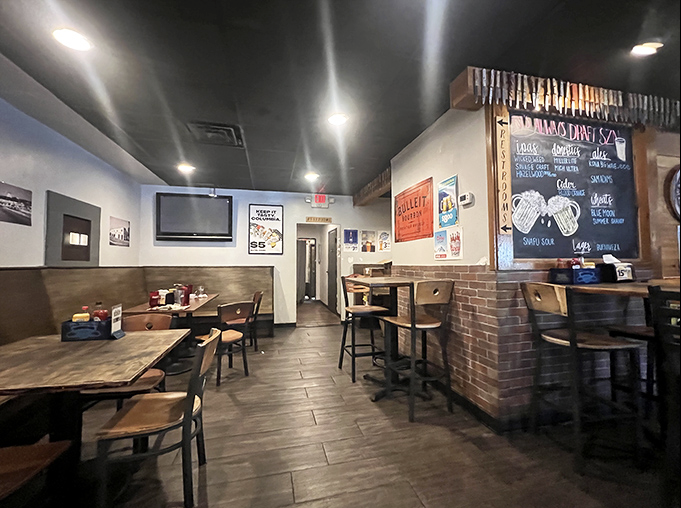 Simple wooden tables, brick accents, and a chalkboard menu create that perfect "neighborhood joint" atmosphere where memorable meals and conversations happen.