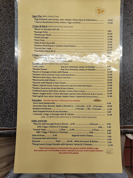 Menu treasure map! Navigating these breakfast and lunch options feels like discovering the lost ark of comfort food. The Flying Saucer pancake alone is worth the expedition.