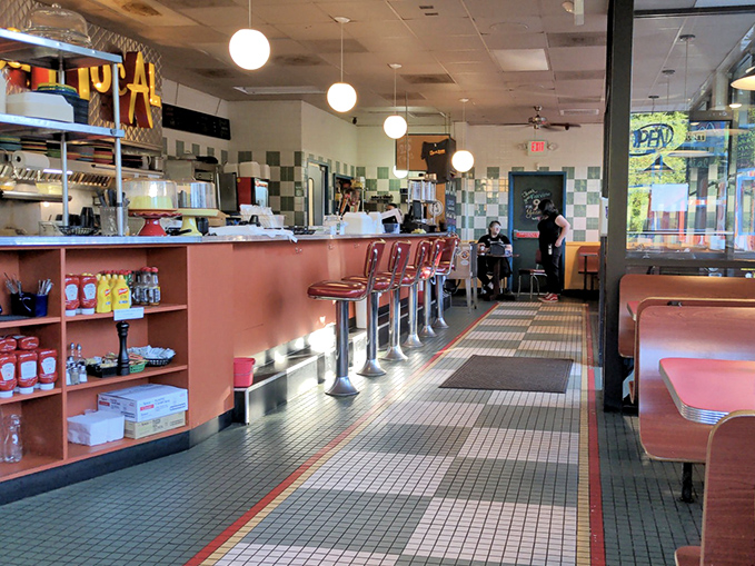 Classic diner aesthetics meet modern comfort inside, where those red counter stools have witnessed countless first bites of breakfast bliss.