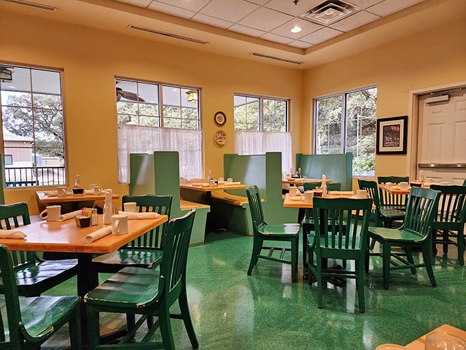 Warm wood tables, green chairs, and natural light create the perfect setting for what's about to be a transcendent breakfast experience.