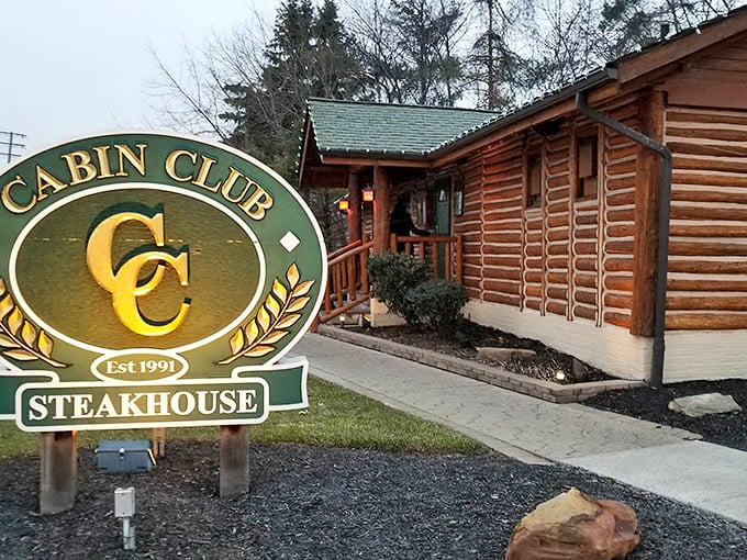 Same exterior shot from a slightly different angle, showcasing the authentic log cabin construction that makes this Westlake steakhouse instantly recognizable.