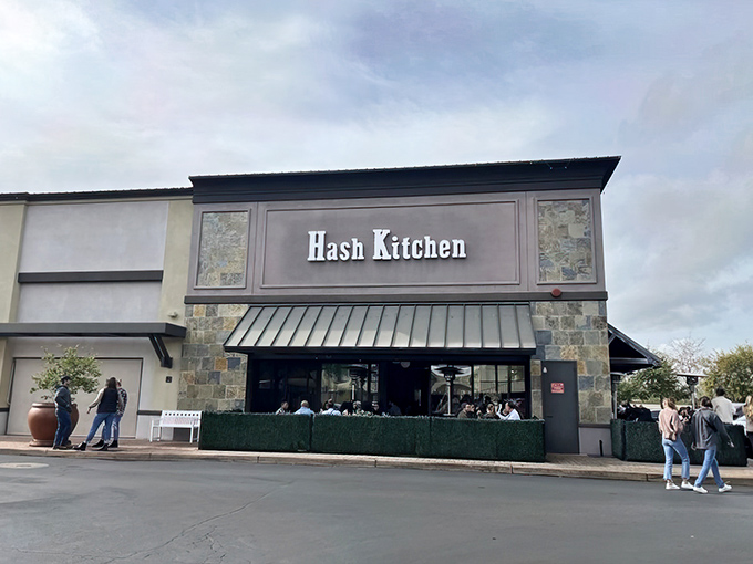 Hash Kitchen's stone-accented exterior beckons like a siren song to breakfast lovers. The patio seating hints at the morning festivities waiting inside.