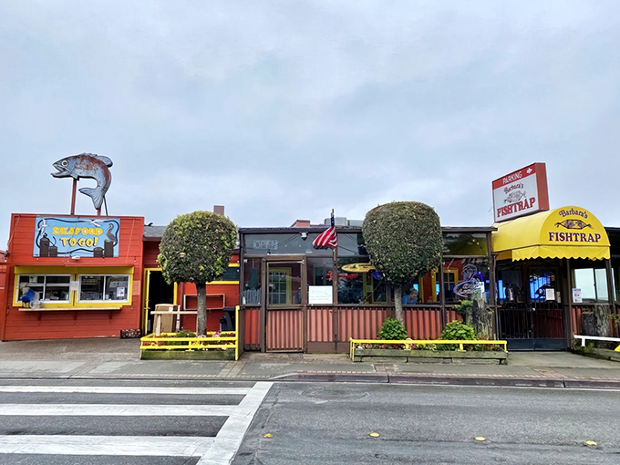 The bright yellow awning and weathered red exterior of Barbara's Fishtrap stands as a beacon for seafood lovers&mdash;no Instagram filters required for this authentic coastal gem.