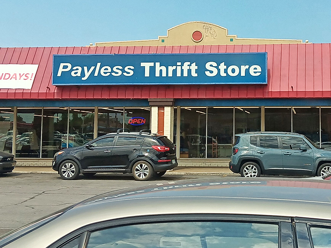 The iconic blue sign of Payless Thrift Store beckons bargain hunters like a retail lighthouse guiding ships to treasure-filled shores.