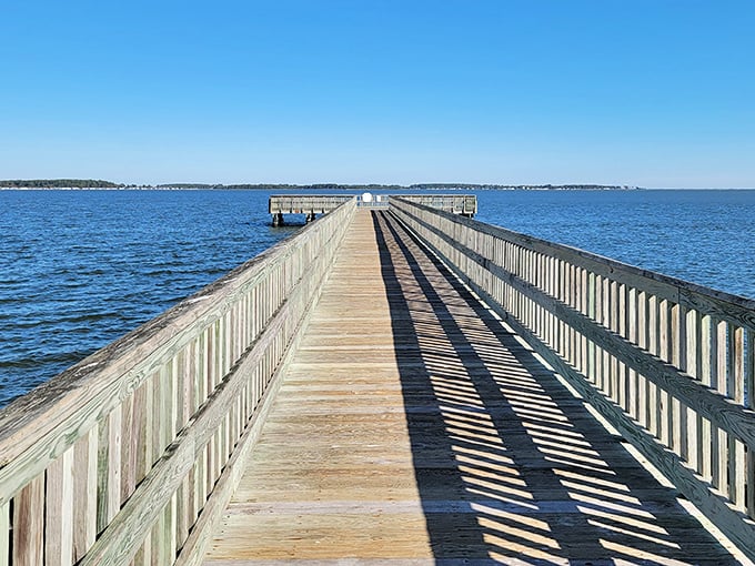 The wooden pier stretches toward infinity, inviting you to walk its planks and discover what waits at the end of this aquatic runway.