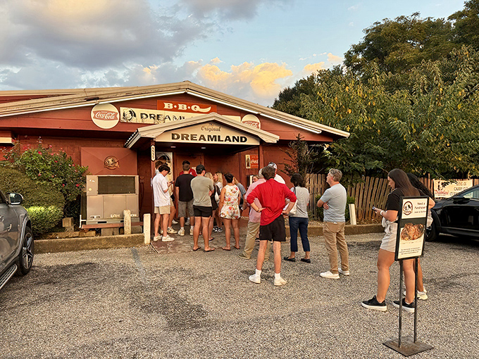 The pilgrimage begins here: a humble red building with a line of devotees waiting for their barbecue baptism at Dreamland's original Tuscaloosa location.