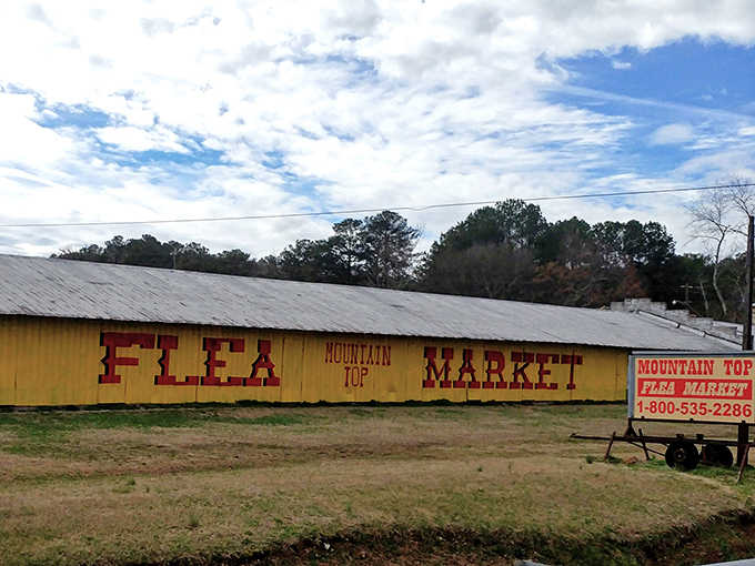 The iconic yellow exterior of Mountain Top Flea Market stands like a beacon of bargain-hunting hope against the Alabama sky. Sunday treasure hunting at its finest.