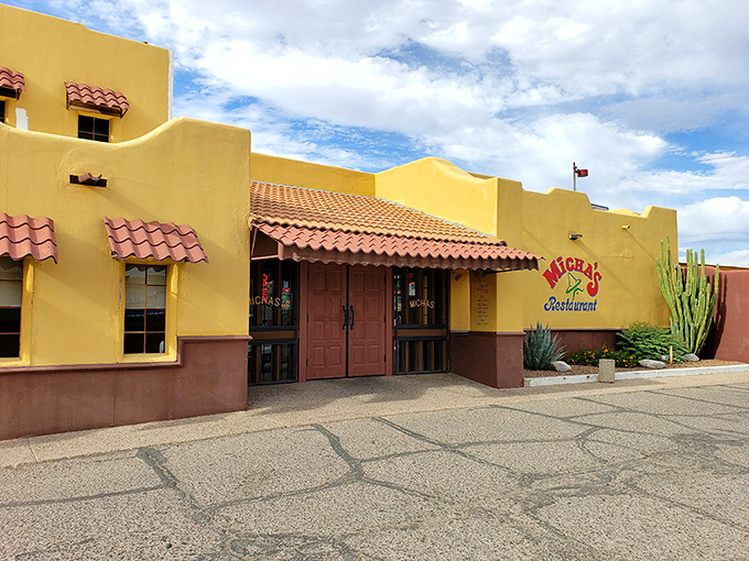 The sunshine-yellow exterior of Micha's stands like a beacon of culinary promise against Tucson's blue sky, its terra cotta roof tiles practically whispering "authentic Mexican food ahead."