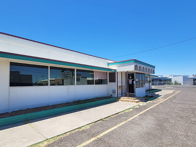 The unassuming exterior of Mel's Diner stands like a time capsule against the Arizona sky, promising comfort food salvation to hungry souls.