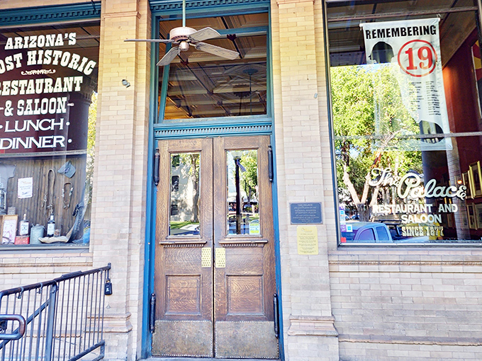 The historic facade of The Palace Restaurant proudly announces itself as "Arizona's Most Historic Restaurant & Saloon," a claim those wooden doors have earned.