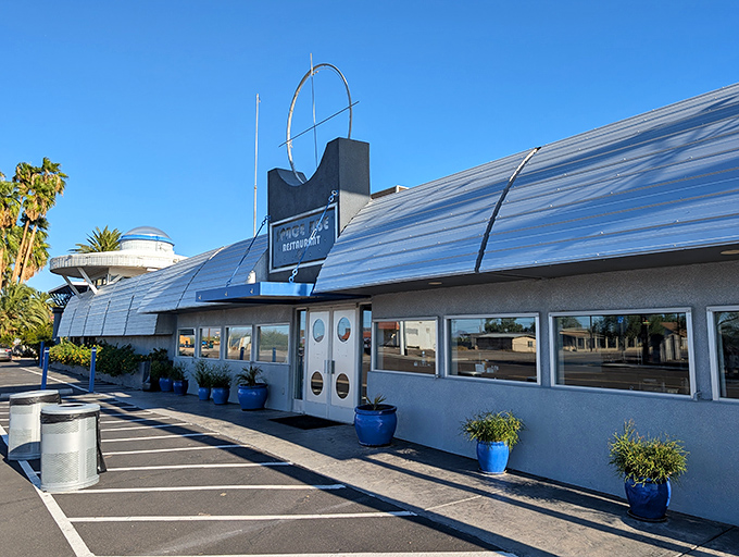 Bright blue planters line the walkway to this retro-futuristic diner, proving that even in the desert, life finds a way&mdash;especially around good food.