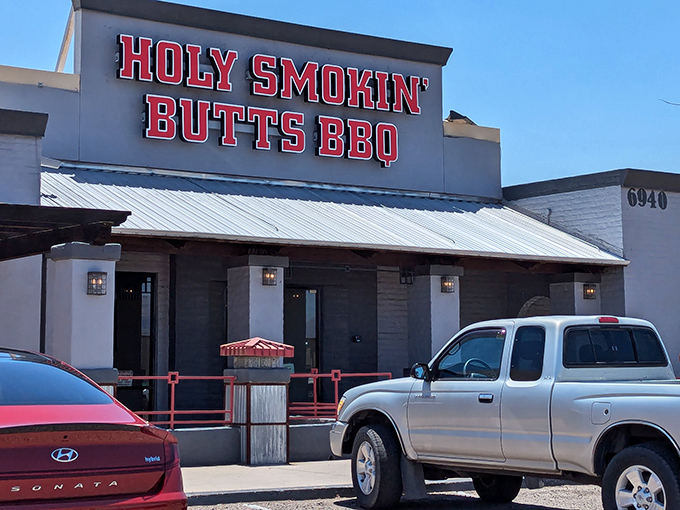 The bold red sign of Holy Smokin&rsquo; Butts BBQ blazes against the Arizona sky, calling hungry carnivores to worship at the altar of smoke and flavor.