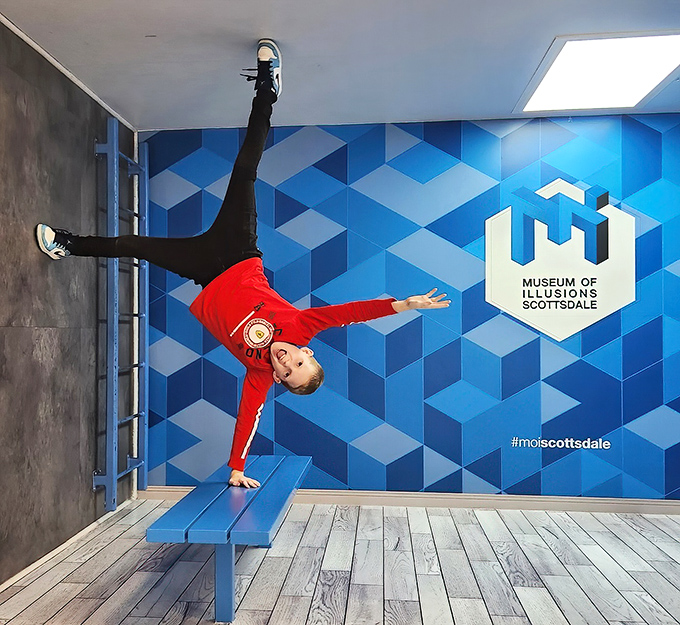 Defying gravity never looked so convincing! This visitor appears to perform Olympic-level gymnastics while actually standing on a cleverly designed bench.