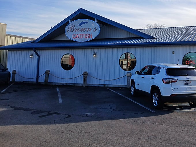 The iconic blue roof of Brown's Catfish stands like a beacon for hungry travelers, promising seafood salvation in landlocked Arkansas.