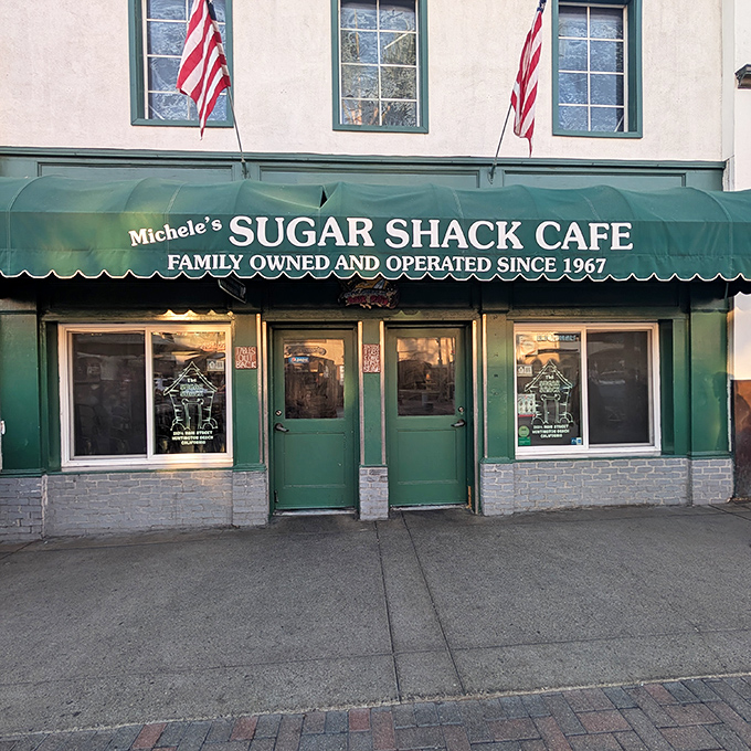 American flags proudly flank the entrance, announcing this isn't just a cafe&mdash;it's a local institution where beach town traditions are served daily alongside the coffee.